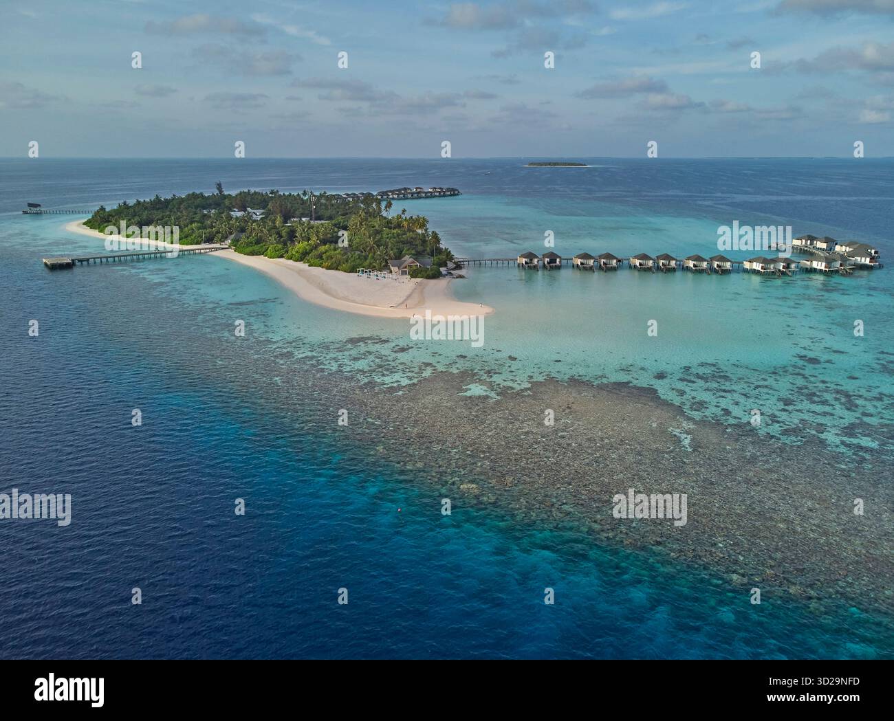 A drone's eye aerial view of beautiful tropical Havodda Island and its ...