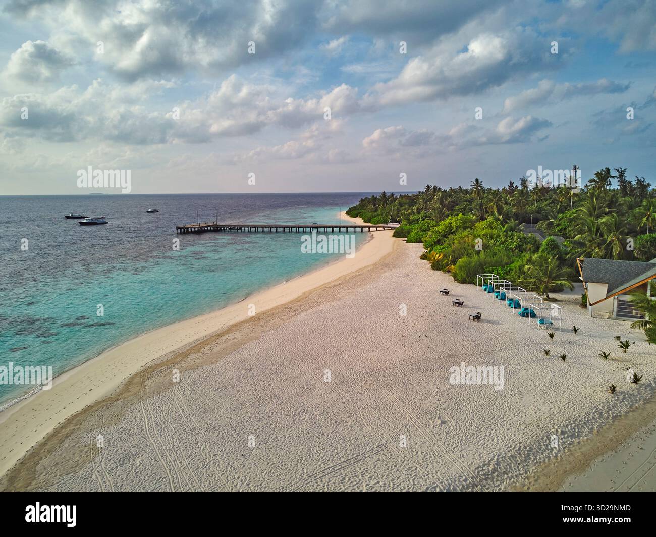 A drone's eye aerial view of beautiful tropical Havodda Island and its ...