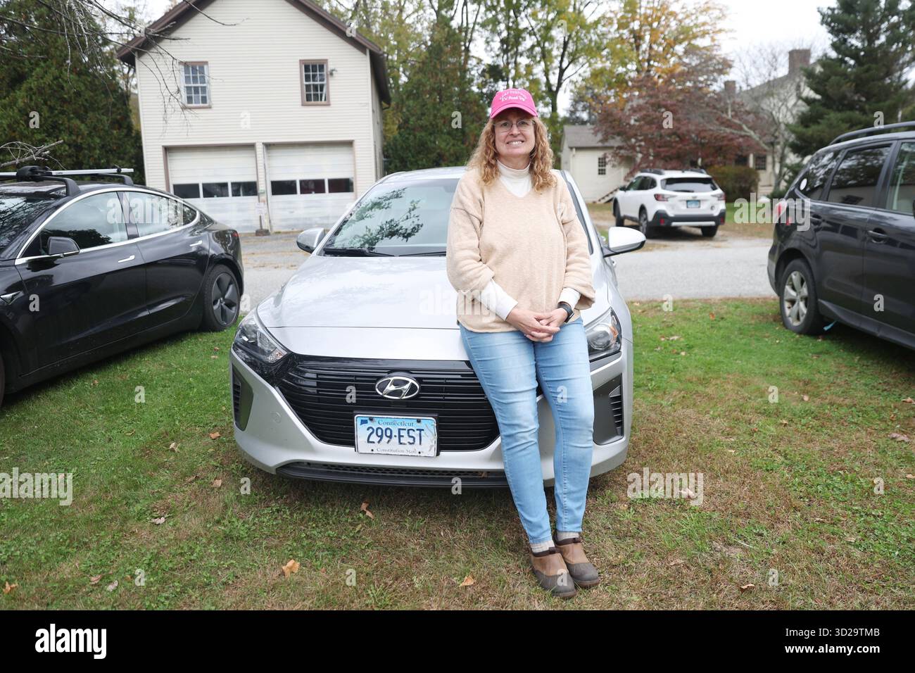 Lynn Mellis Worthington poses for a portrait with her hybrid vehicle ...