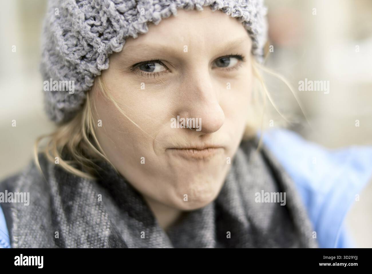 Stubborn woman pressing lips together amids freezing cold temperatures ...