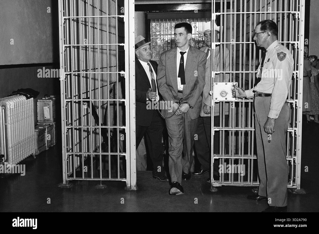FILE - John Gilbert Graham, center, walks through a gate opened by a ...