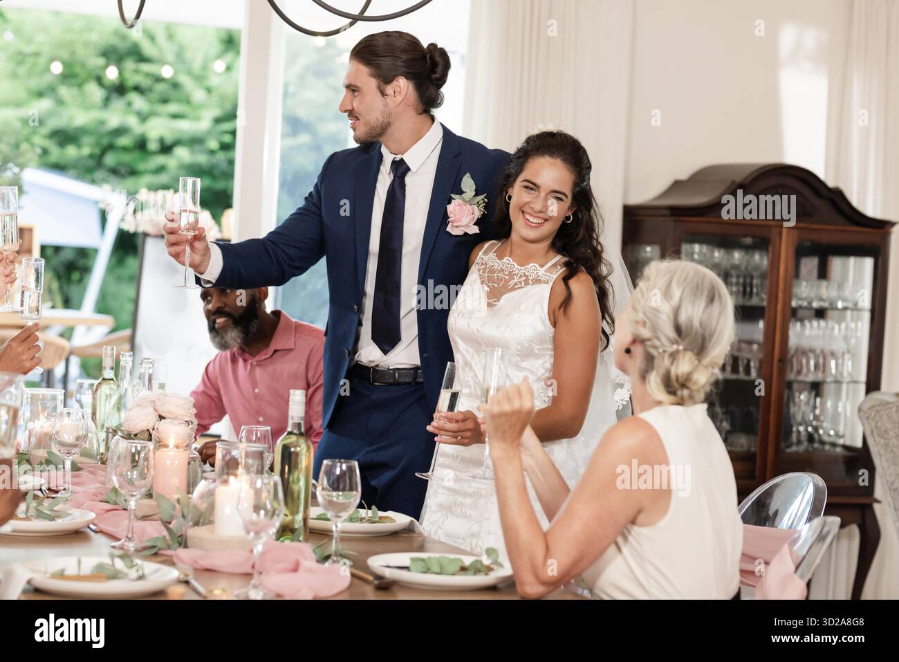Bride and groom toasting with guests at elegant wedding reception ...