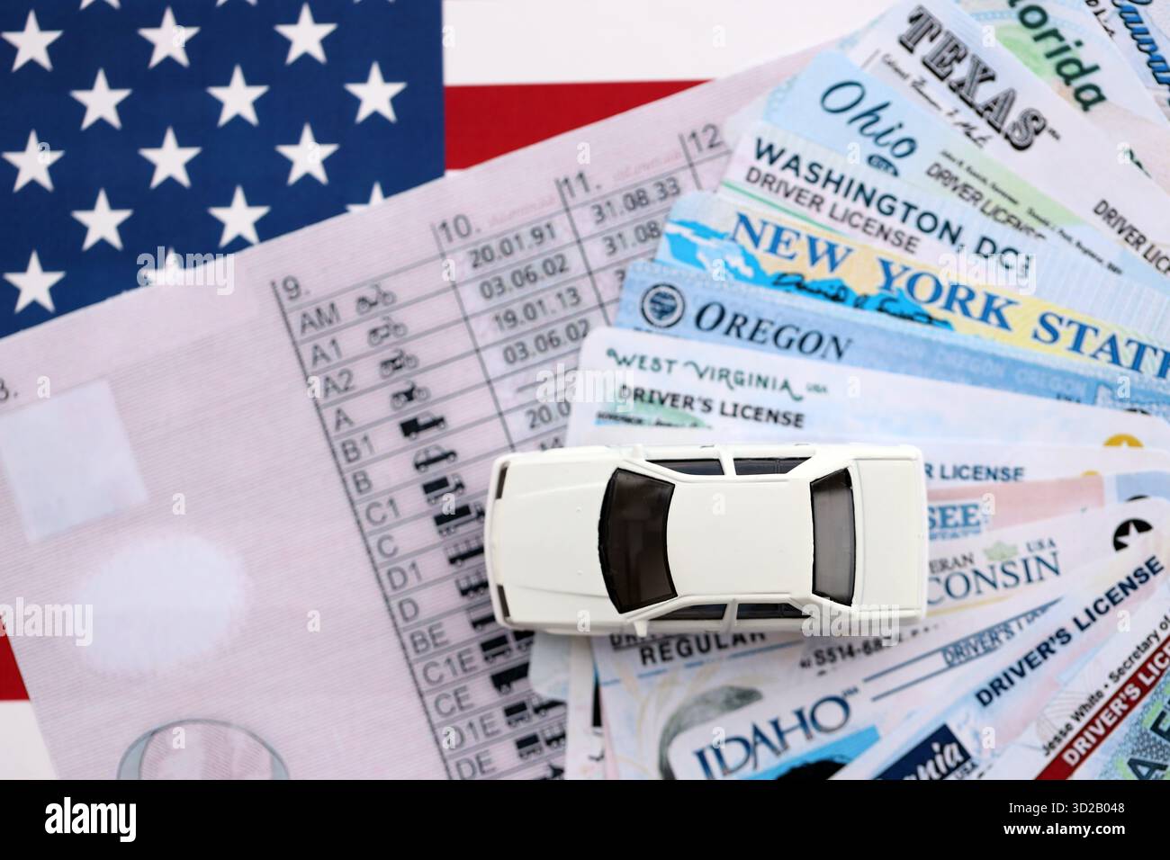 Toy car on big amount of driving licenses from different USA states on ...