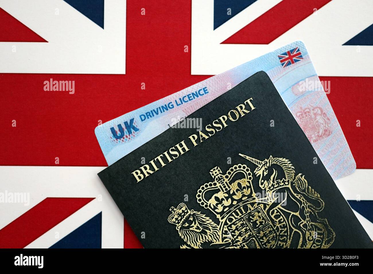 United Kingdom driving license with passport on UK flag close up Stock ...