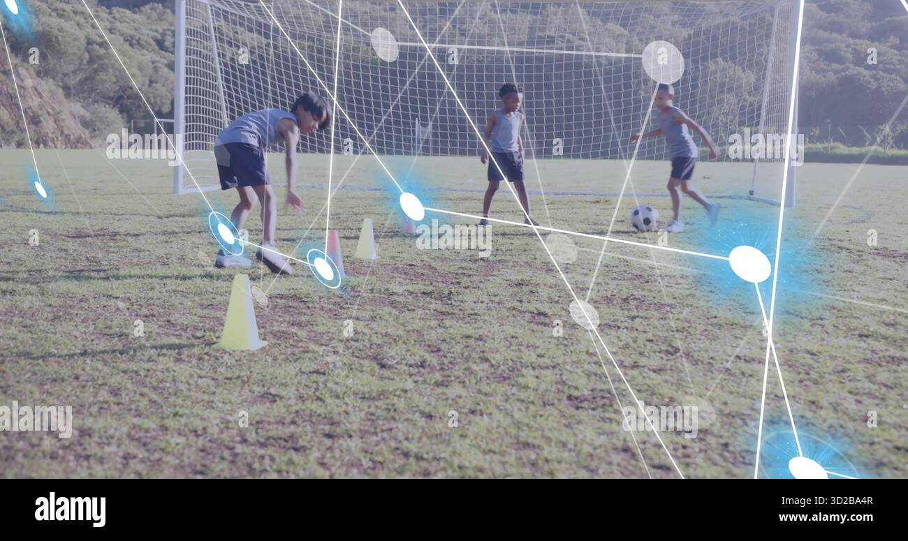 Practicing three boys dribbling soccer ball through yellow cones on ...