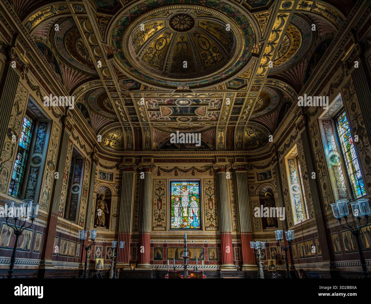 Interior of ornately decorated gilded chapel with stained glass windows ...