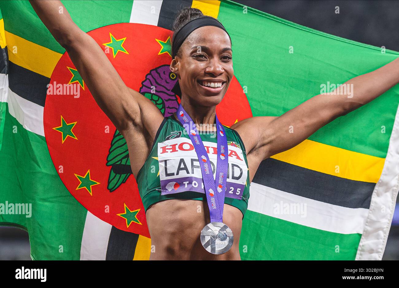 Thea Lafond celebrating her medal with her country's flag at the 2025 ...