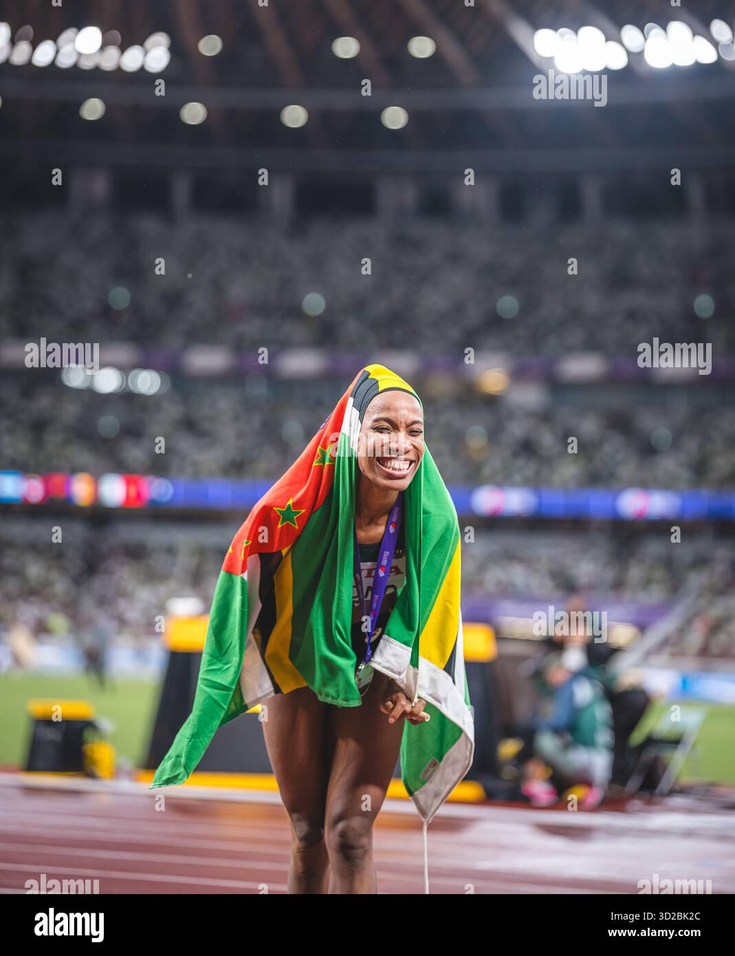 Thea Lafond celebrating her medal with her country's flag at the 2025 ...