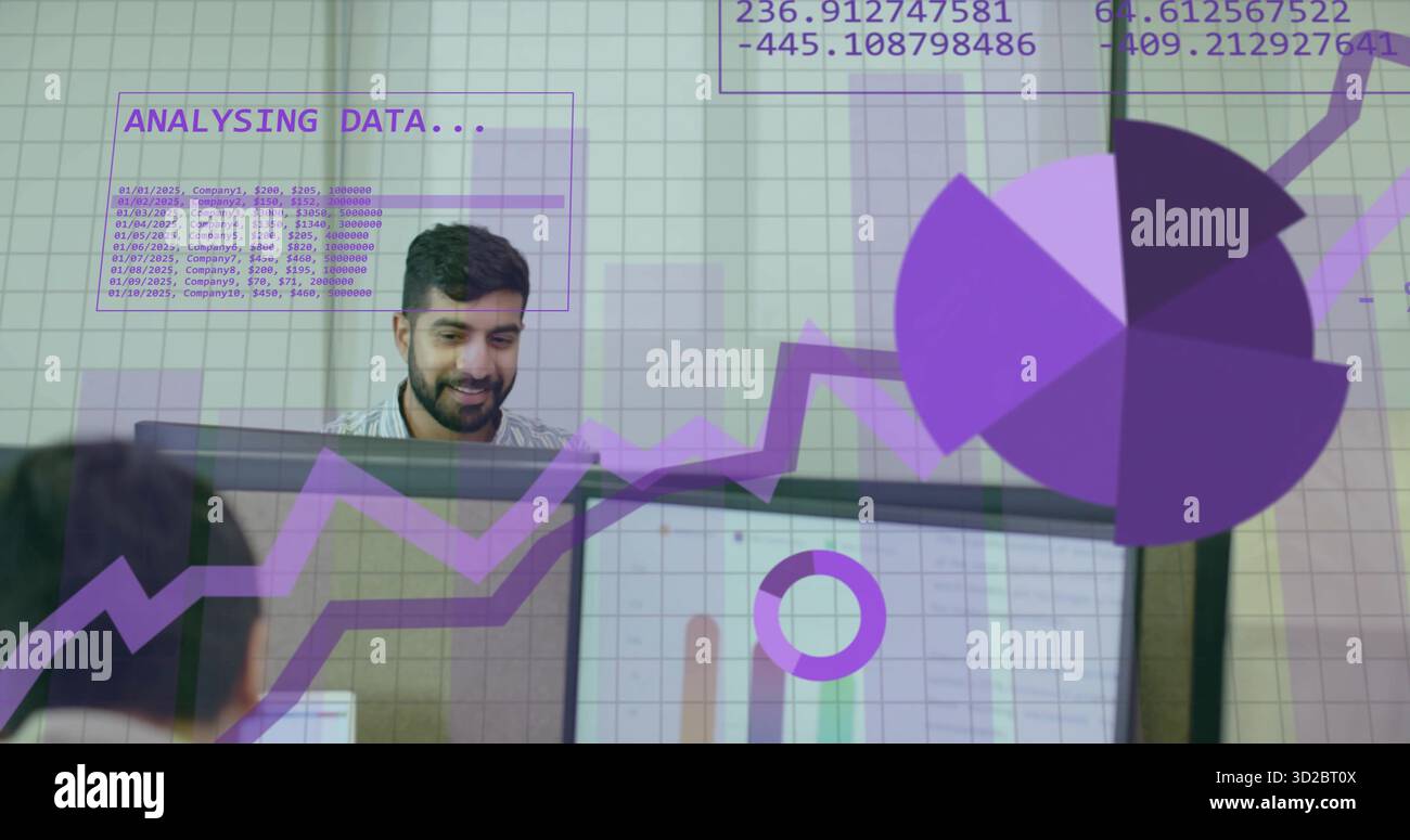 Analyzing data on dual monitors, data analyst working at office cubicle ...