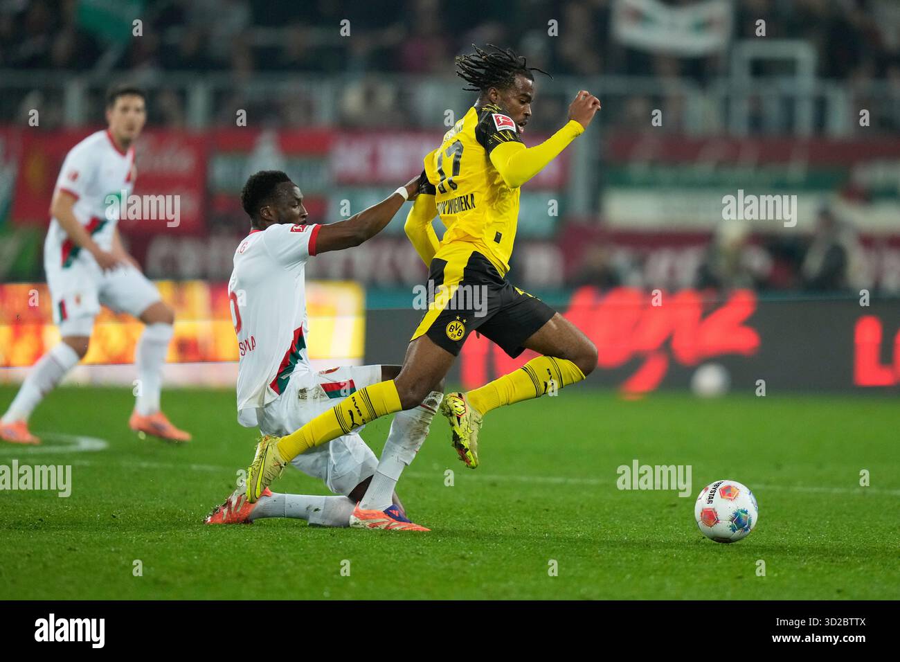 Augsburg's Chrislain Matsima, left, challenges for the ball with ...
