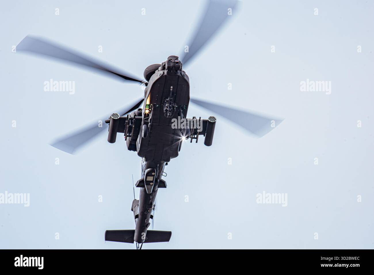 Low angle view of a Boeing AH-64 Apache military helicopter flying ...