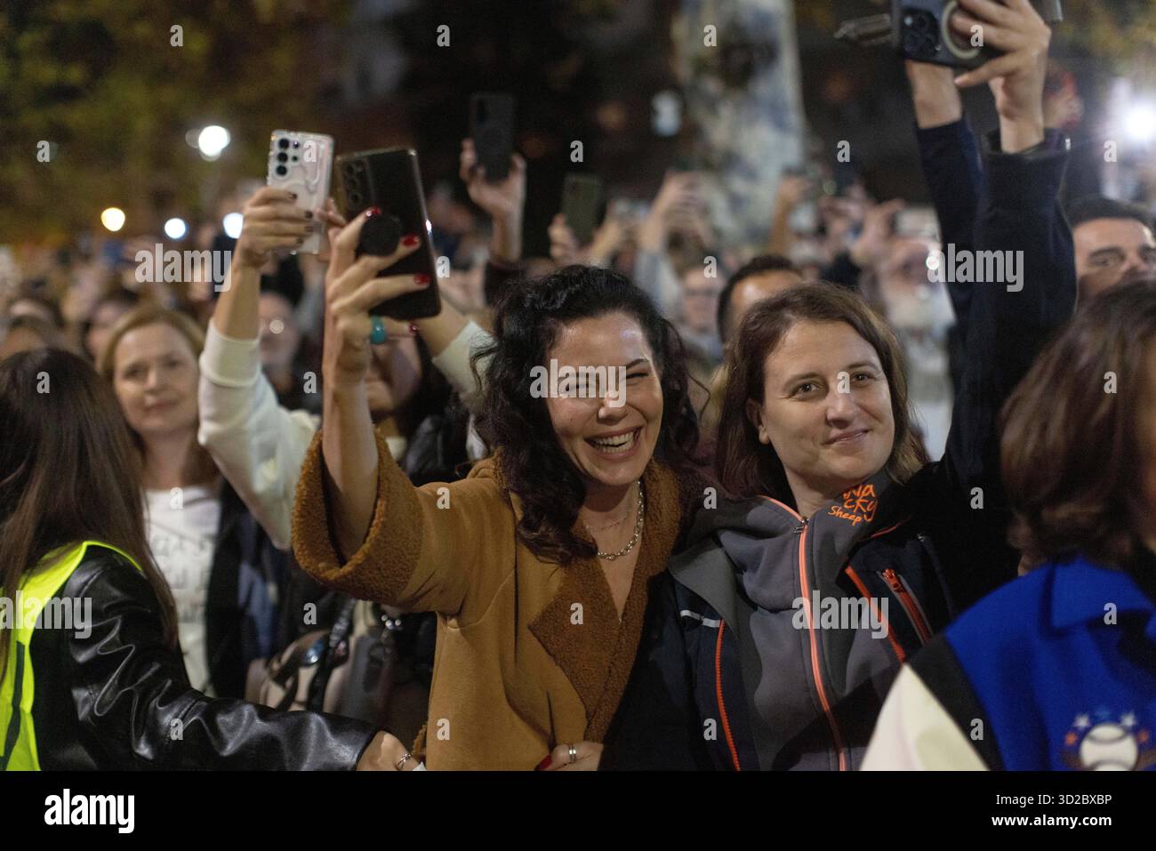 A woman smiles as a group of students arrive before a rally on Nov. 1 ...