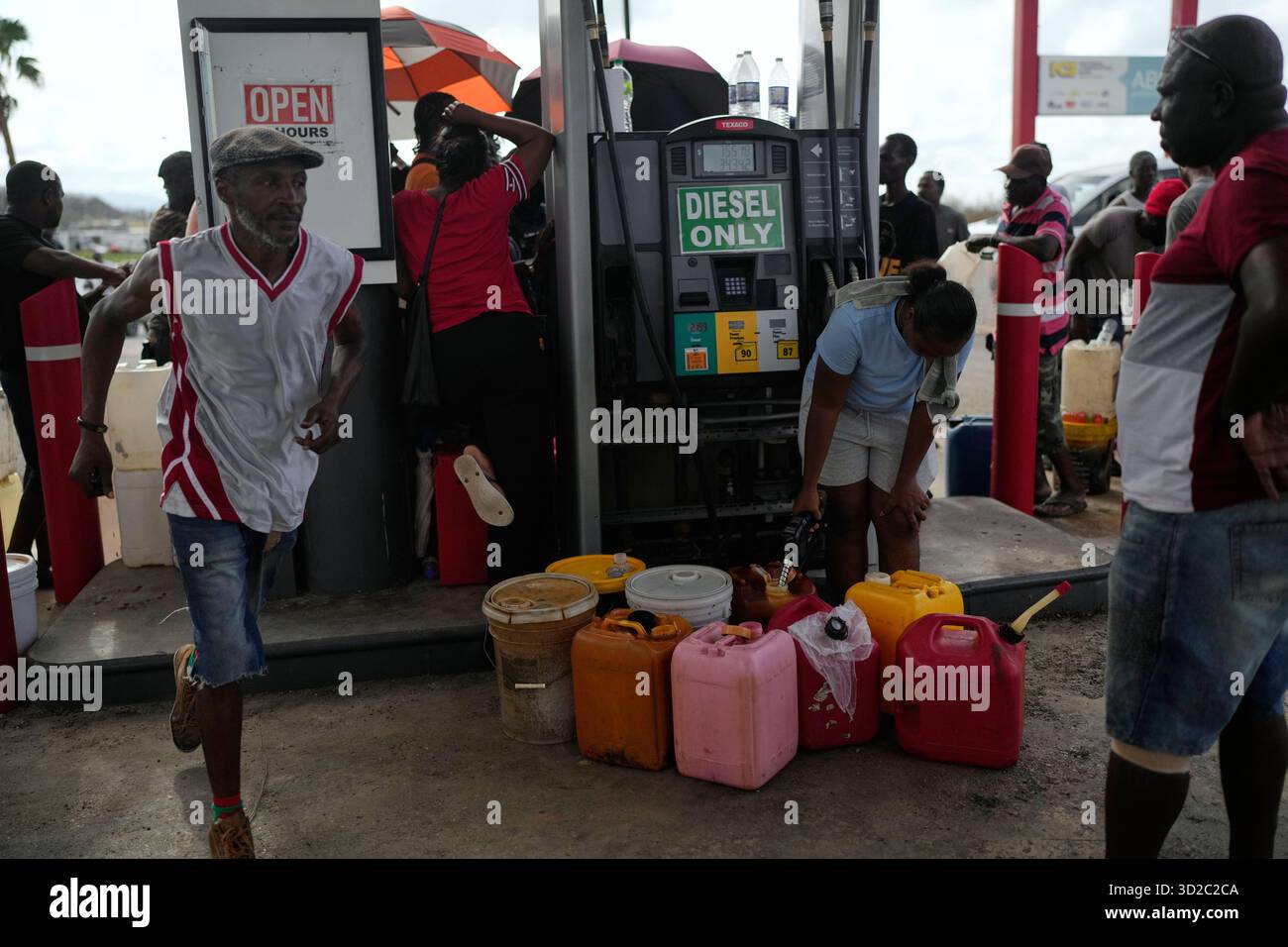 People line up for fuel in Montego Bay, Jamaica, Friday, Oct. 31, 2025 ...
