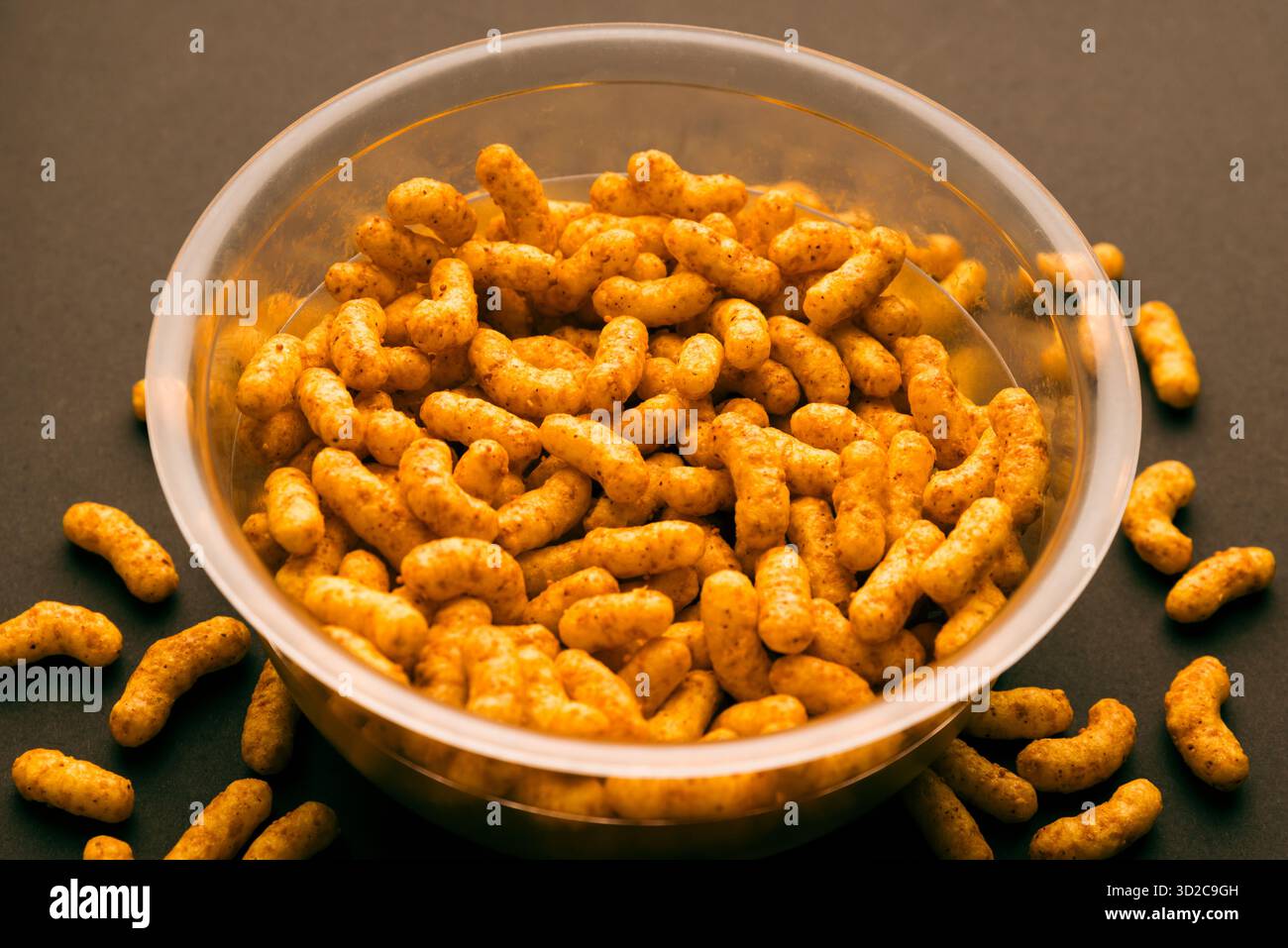 Plastic bowl filled with peanut puff snacks, crispy and golden, ideal ...