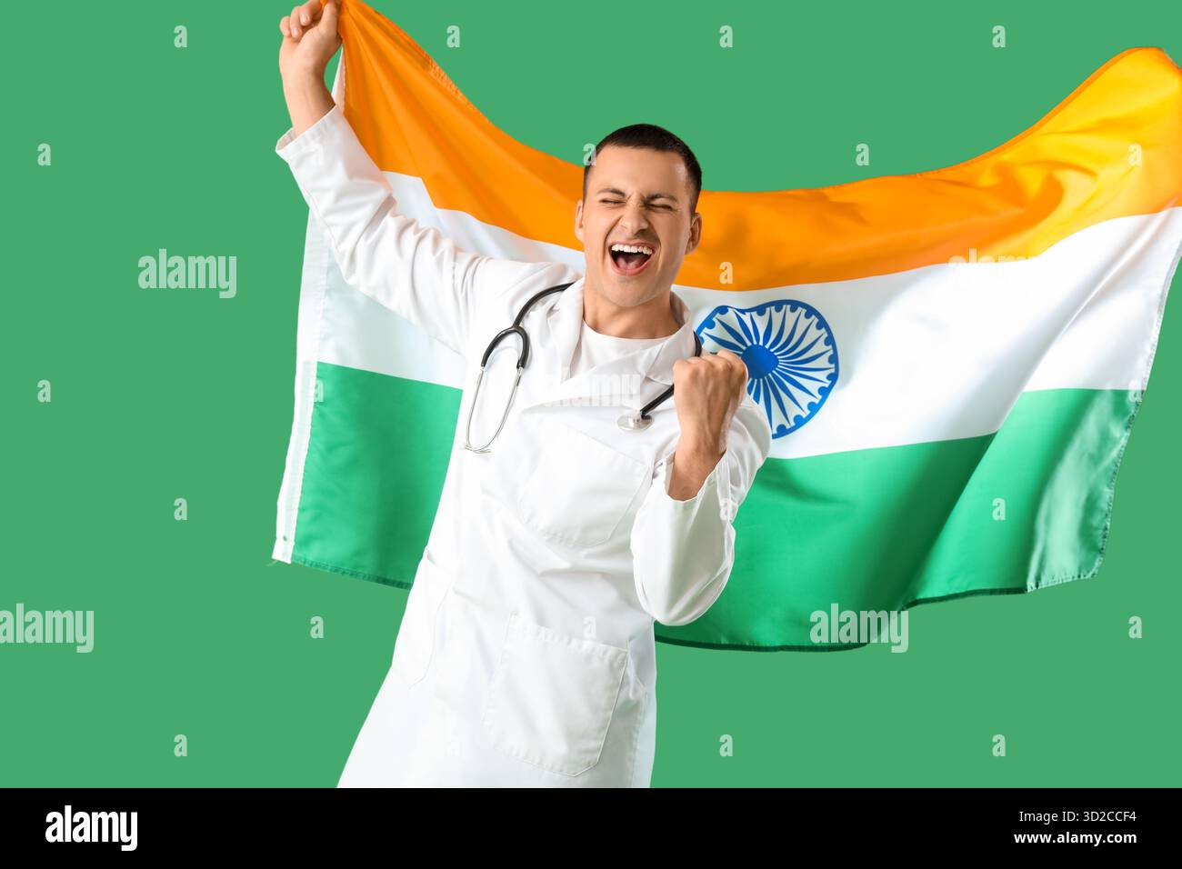 Happy male doctor with flag of India on green background. National ...