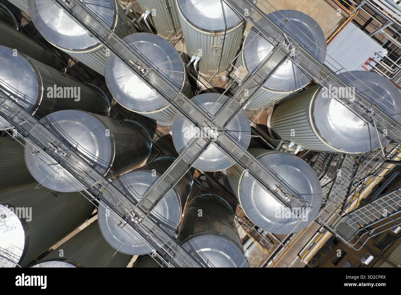 aerial view of large, stainless steel fermentation tanks at a brewery ...