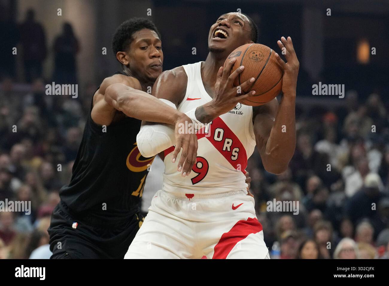 Toronto Raptors' RJ Barrett (9) is fouled by Cleveland Cavaliers' De ...