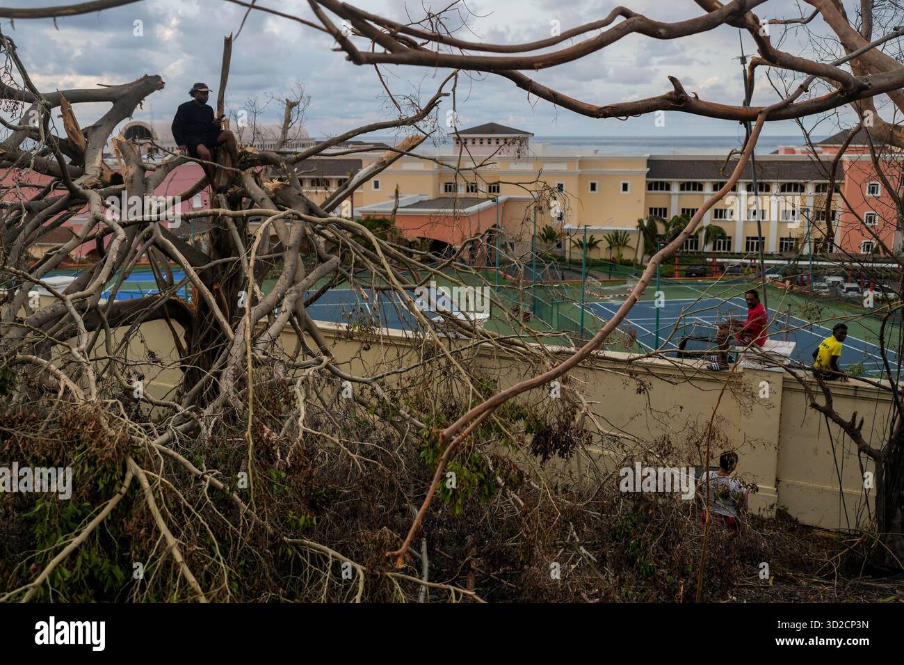 Locals gather next to a resort in Montego Bay, Jamaica, Friday, Oct. 31 ...