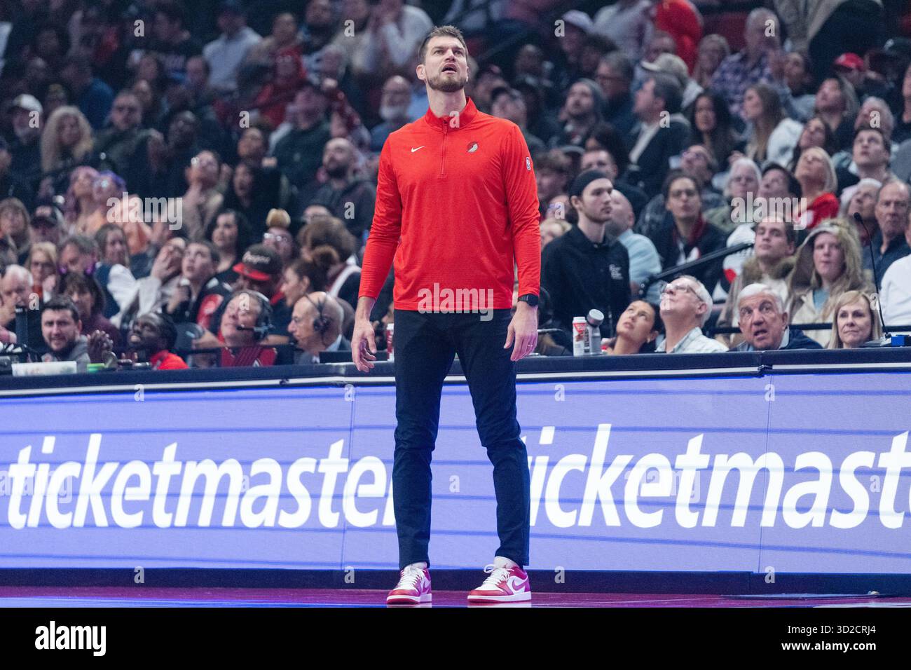 Portland Trail Blazers interim head coach Tiago Splitter looks up at ...