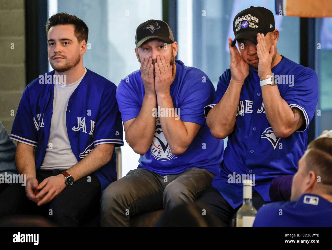 Baseball fans react as they watch the Toronto Blue Jays and Los Angeles ...