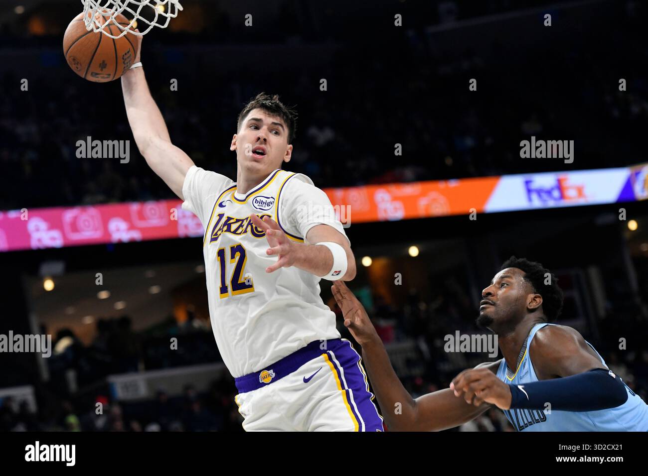 Los Angeles Lakers forward Jake LaRavia (12) grabs a rebound over ...