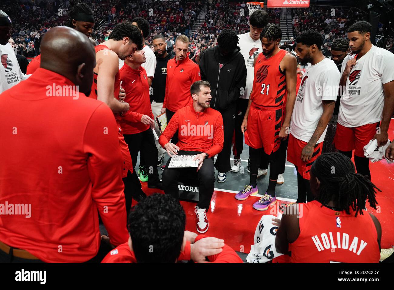 Portland Trail Blazers interim head coach Tiago Splitter, center, talks ...