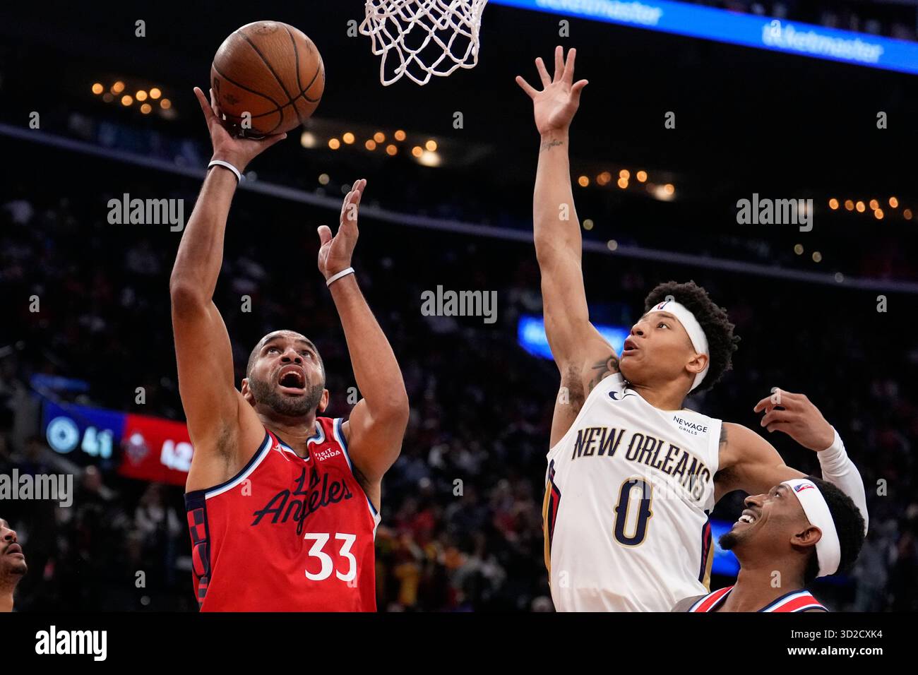 Los Angeles Clippers forward Nicolas Batum, left, shoots as New Orleans ...