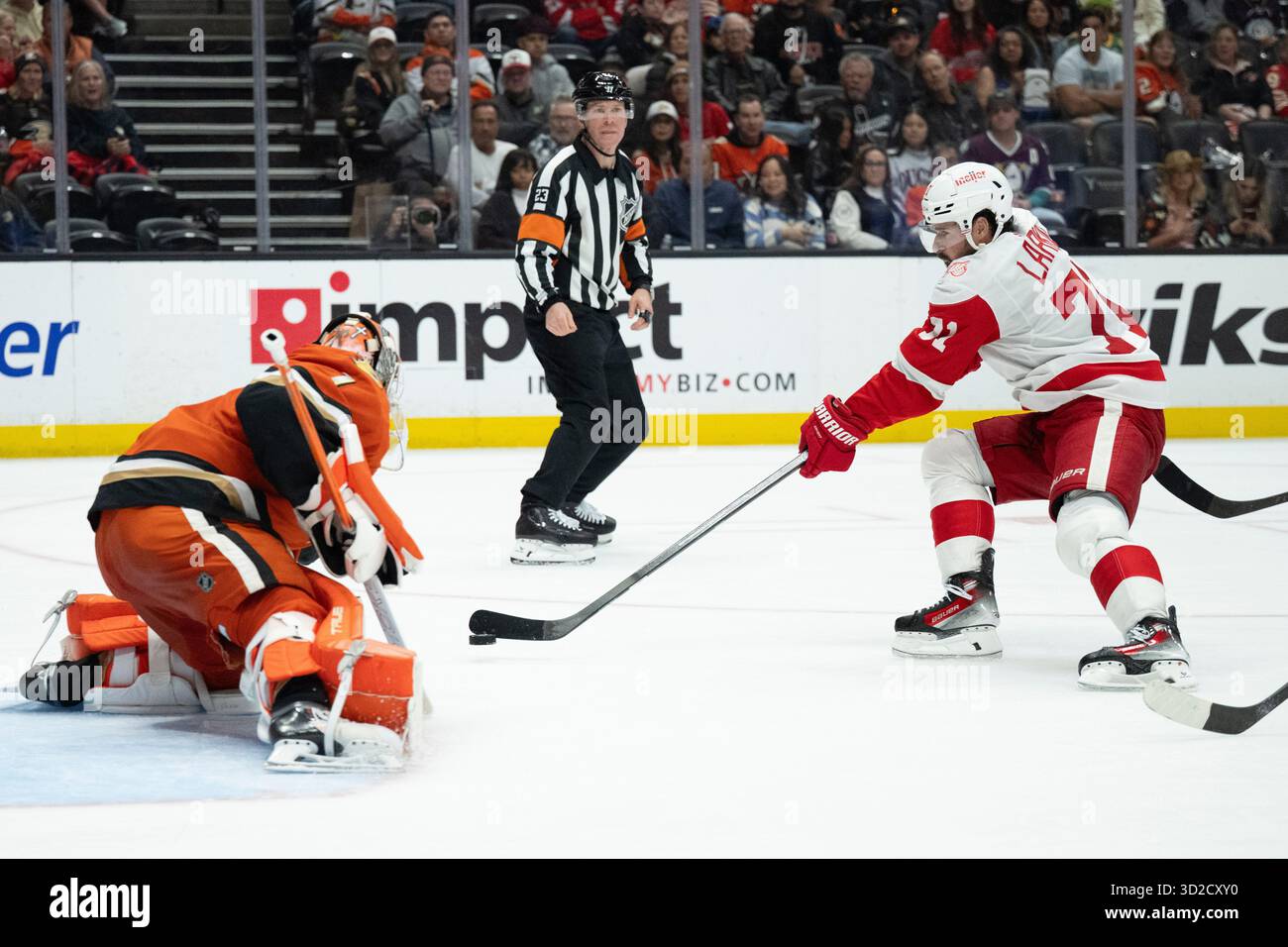 Detroit Red Wings center Dylan Larkin, right, shoots as Anaheim Ducks goaltender Lukas Dostal (1 ...