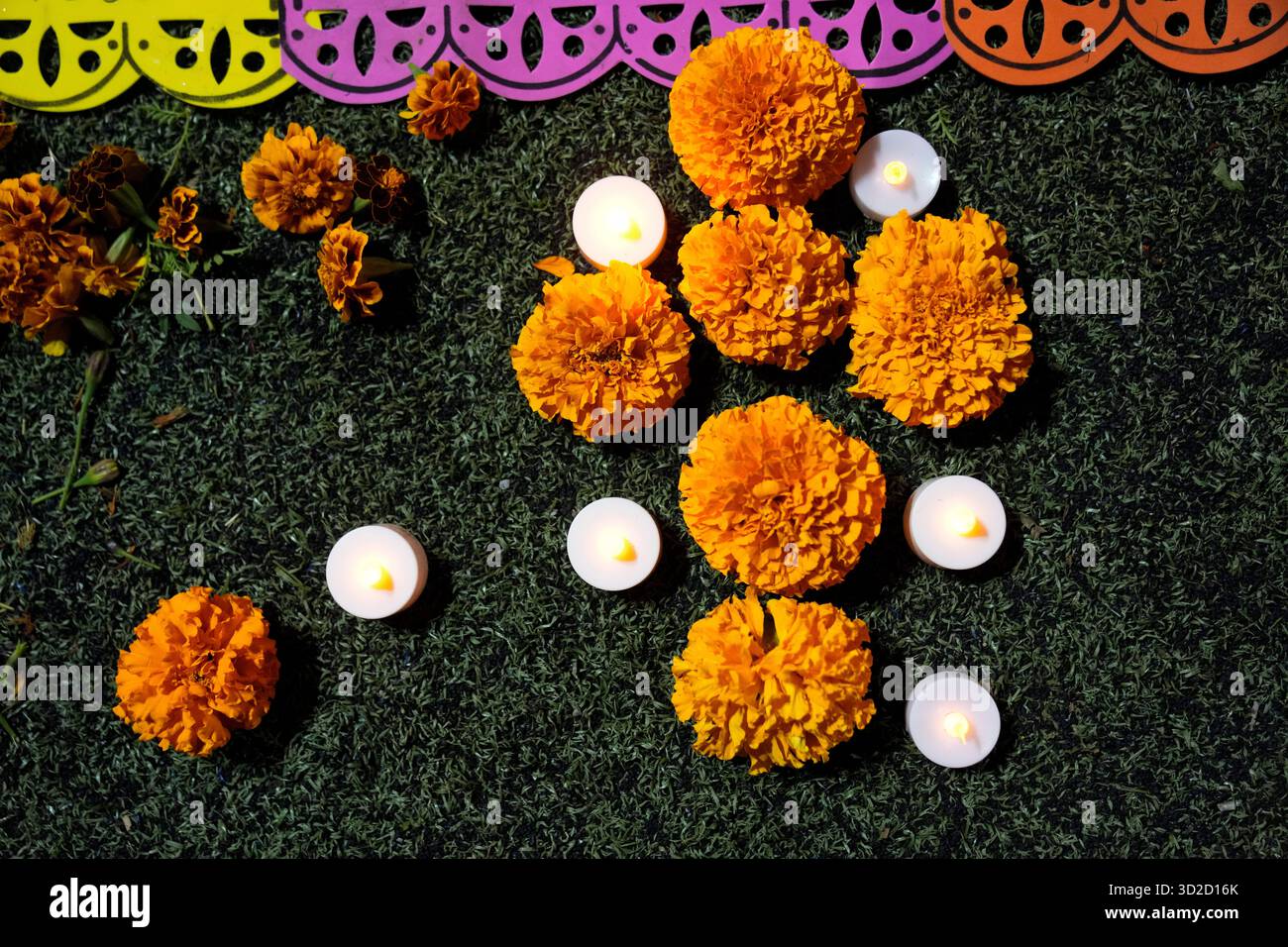 Marigolds in the shape of a cross are part of a Día de Muertos ofrenda ...