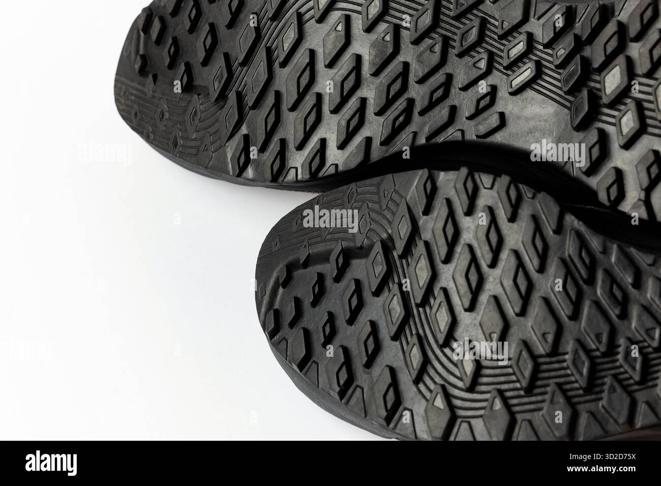 Hiking boot soles on a white background. Details of the grippy tread ...