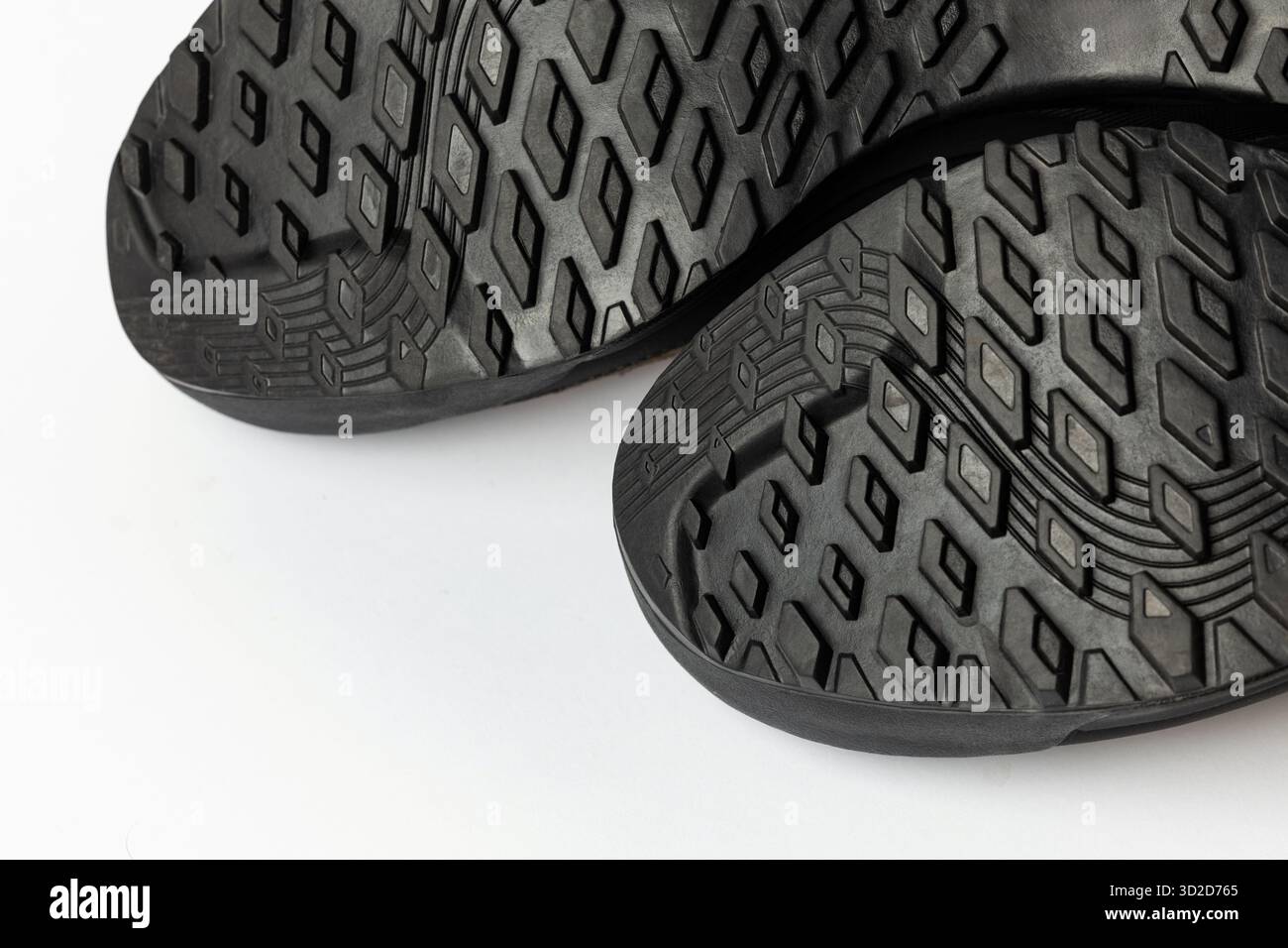 Hiking boot soles on a white background. Details of the grippy tread ...