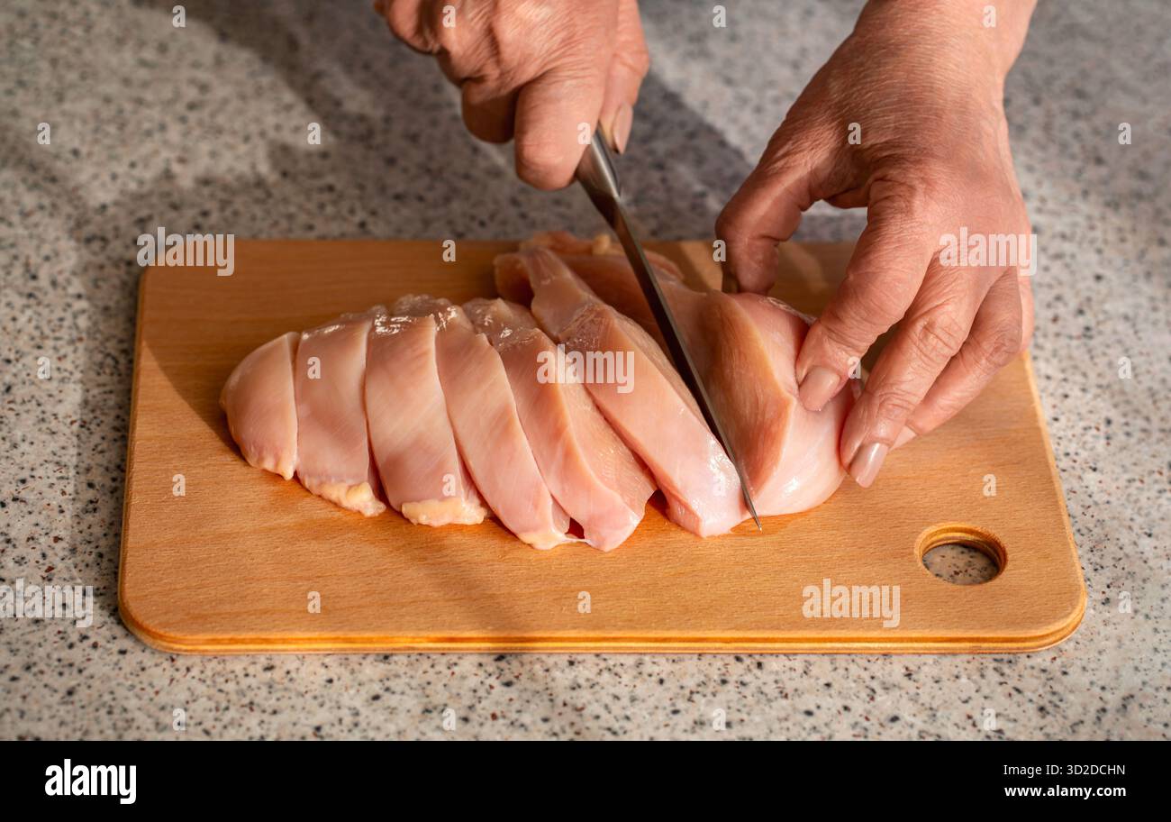 Female chef cuts raw chicken hi-res stock photography and images - Alamy