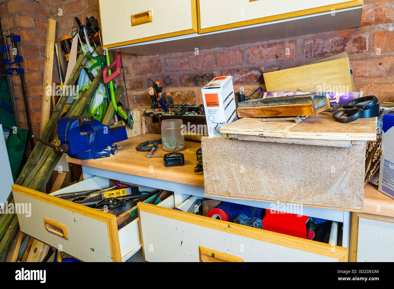 A messy workbench in a workshop, Untidy workman leaves tools all over ...