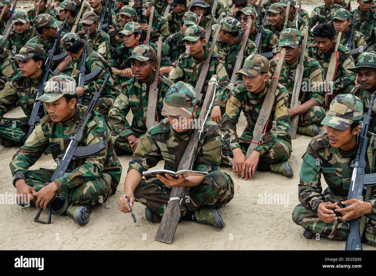 Soldiers from the Battalion 12 in Shwe Bo District sit in formation ...