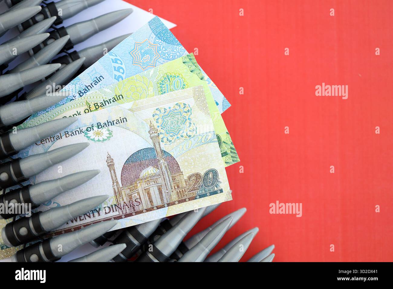 Bahraini dinar currency money bills and rifle bullets on flag close up ...