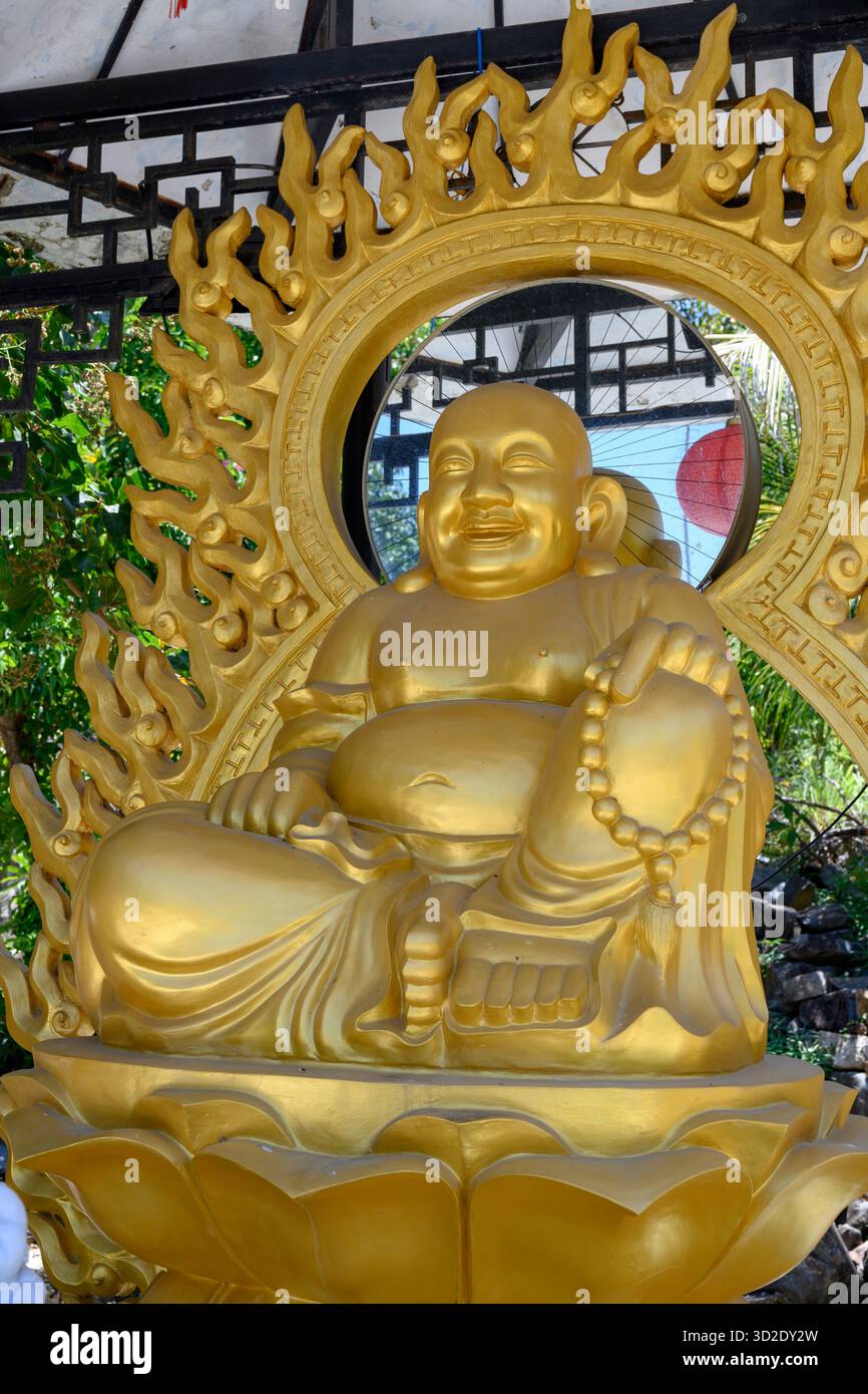 NHA TRANG, VIETNAM - APRIL 28, 2025. Gilded sculpture of smiling Buddha ...