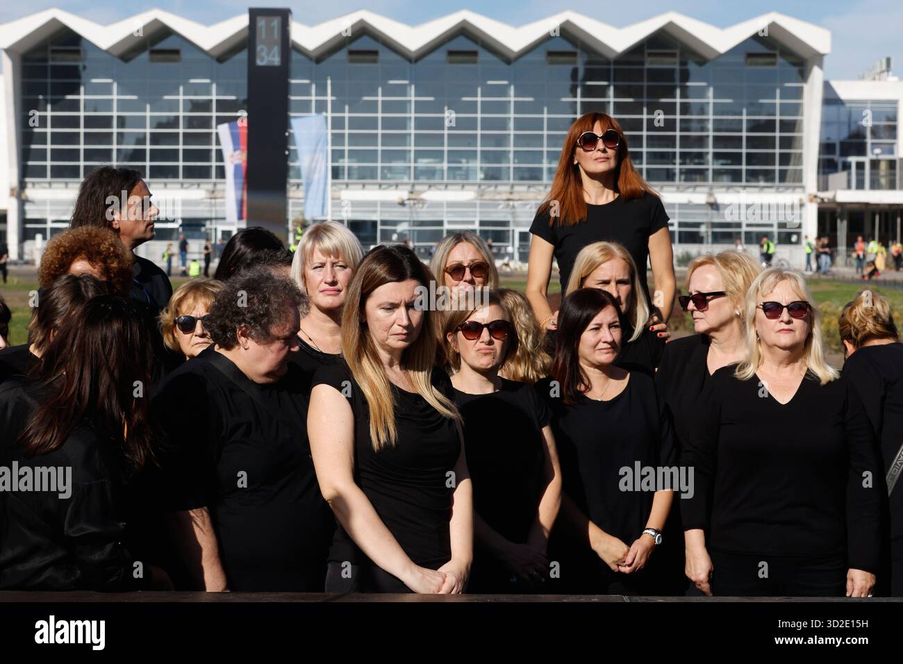 Members of a choir stand outside the train station, on the first ...