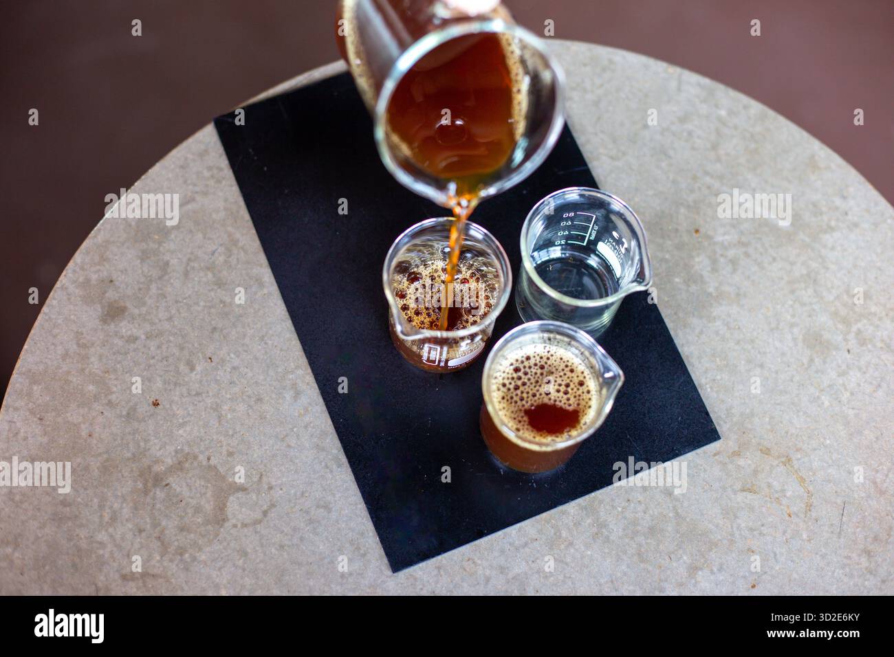 selective focus black coffee in a clear glass Pouring coffee from a ...