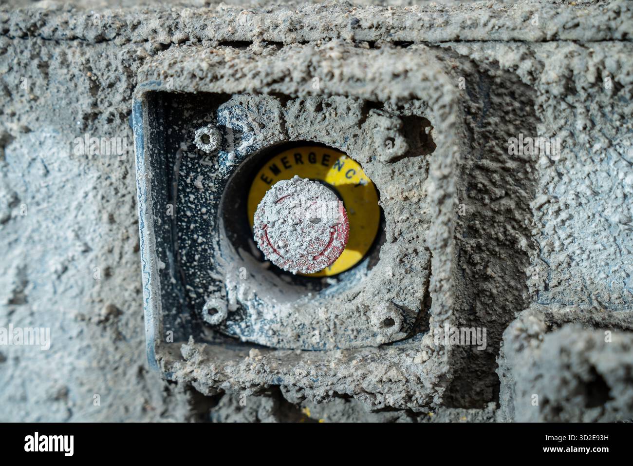 Emergency stop button on heavy construction machinery covered in dried ...