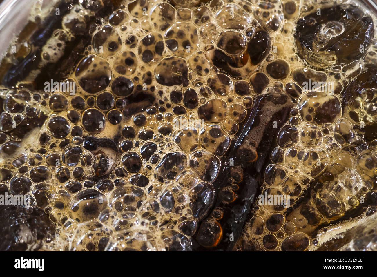 Close up abstract background texture of brown liquid during ...