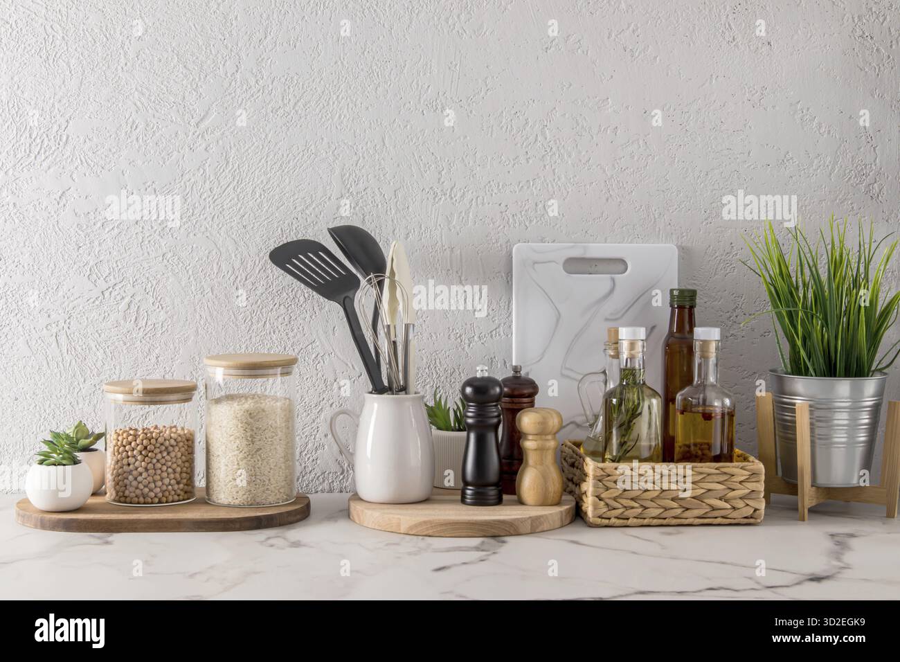 A wide range of kitchen utensils on a marble white countertop. kitchen ...