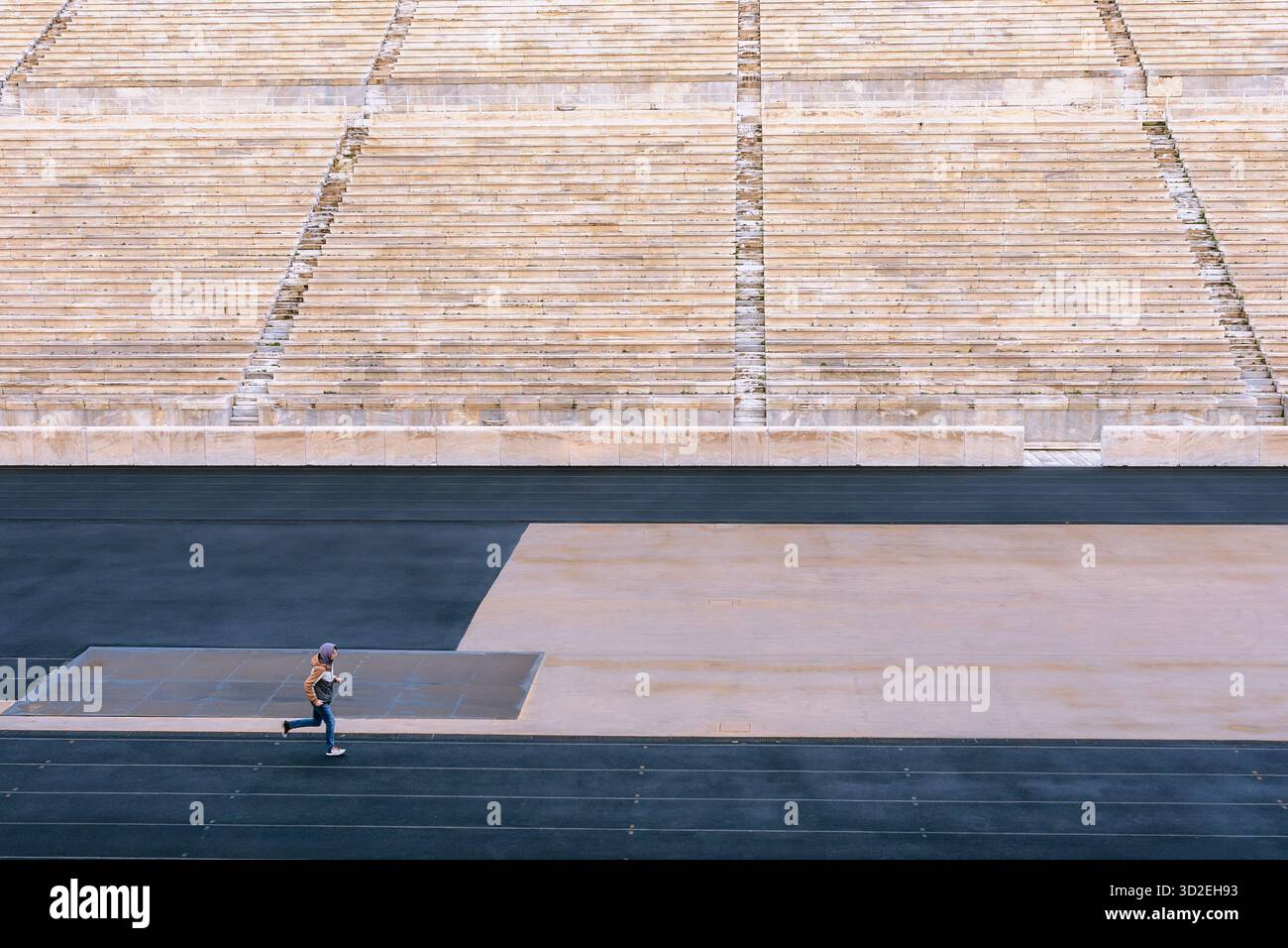 A single runner trains on running track of Athens historic Panathenaic ...