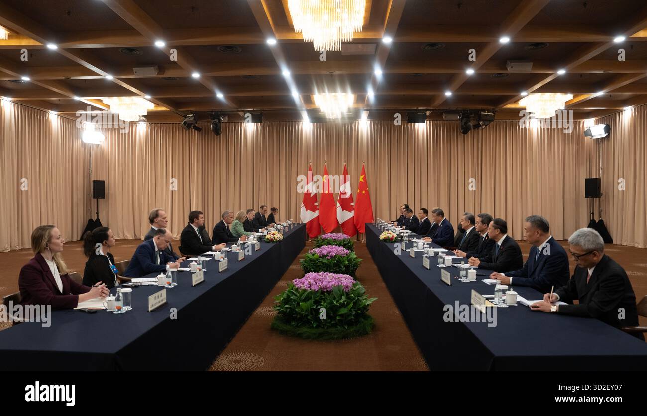 Canadian Prime Minister Mark Carney and the Canadian delegation sit ...