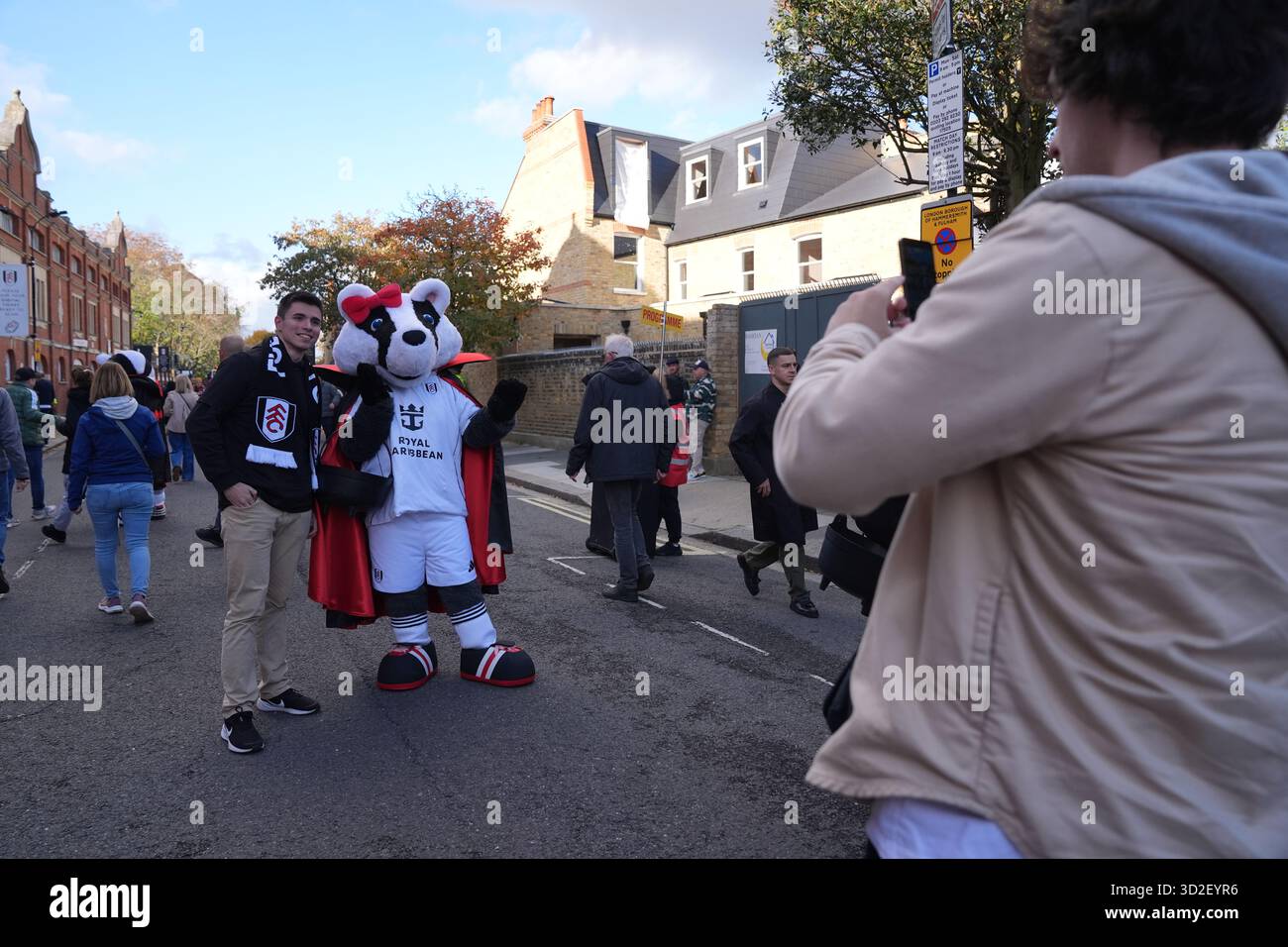 Fulham FC mascot Bella the Badger with fans ahead of the Premier League ...
