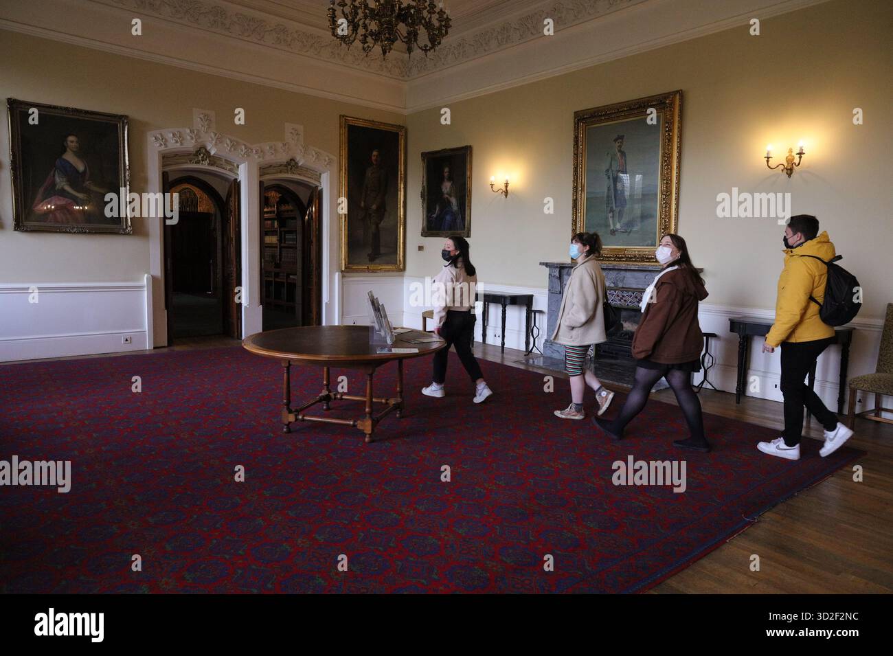 Tourists inside the ornate rooms of Cardiff Castle, Wales Stock Photo ...