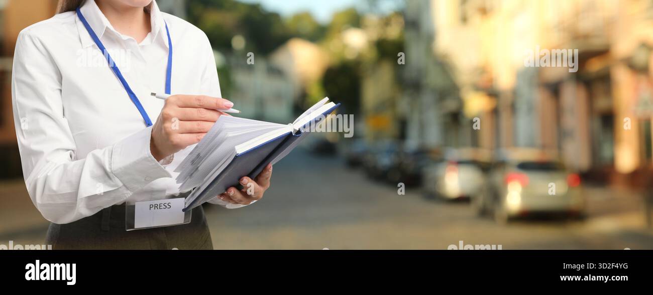 Journalist writing in notebook outdoors, closeup. Banner design Stock ...