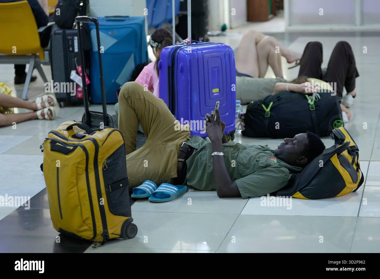 Stranded passengers sleep on the floor waiting for their flight at the ...