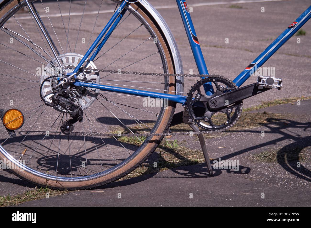 Rear wheel, chain, and gear mechanism of a vintage blue bicycle ...