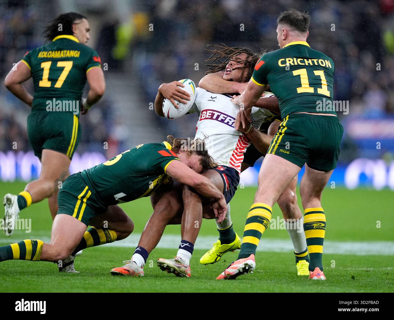 England's Dom Young is tackled by Australia's Reuben Cotter (left) and ...
