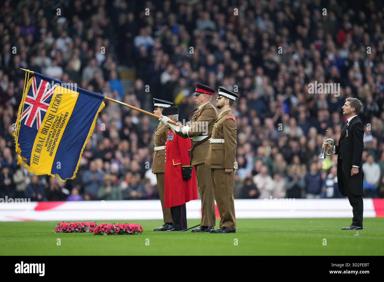 A Chelsea Pensioner with military personnel on the field to mark ...
